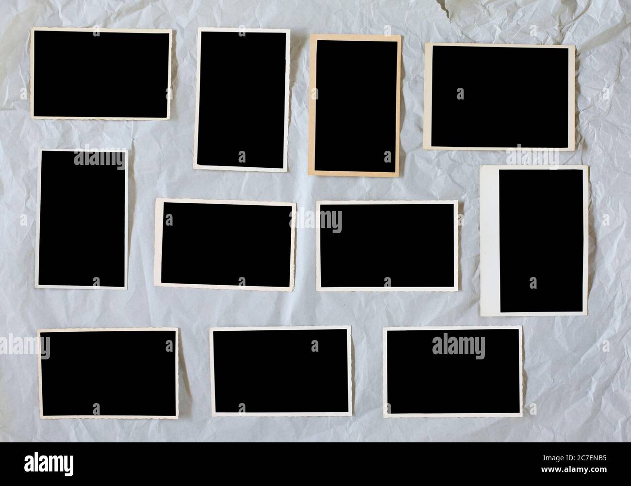 old empty photo frames, vintage photo prints on crumpled paper with ...