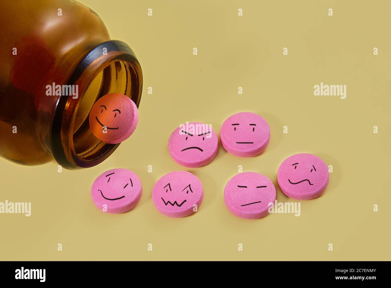 the concept of antidepressants. pills with different emotions fall out ...