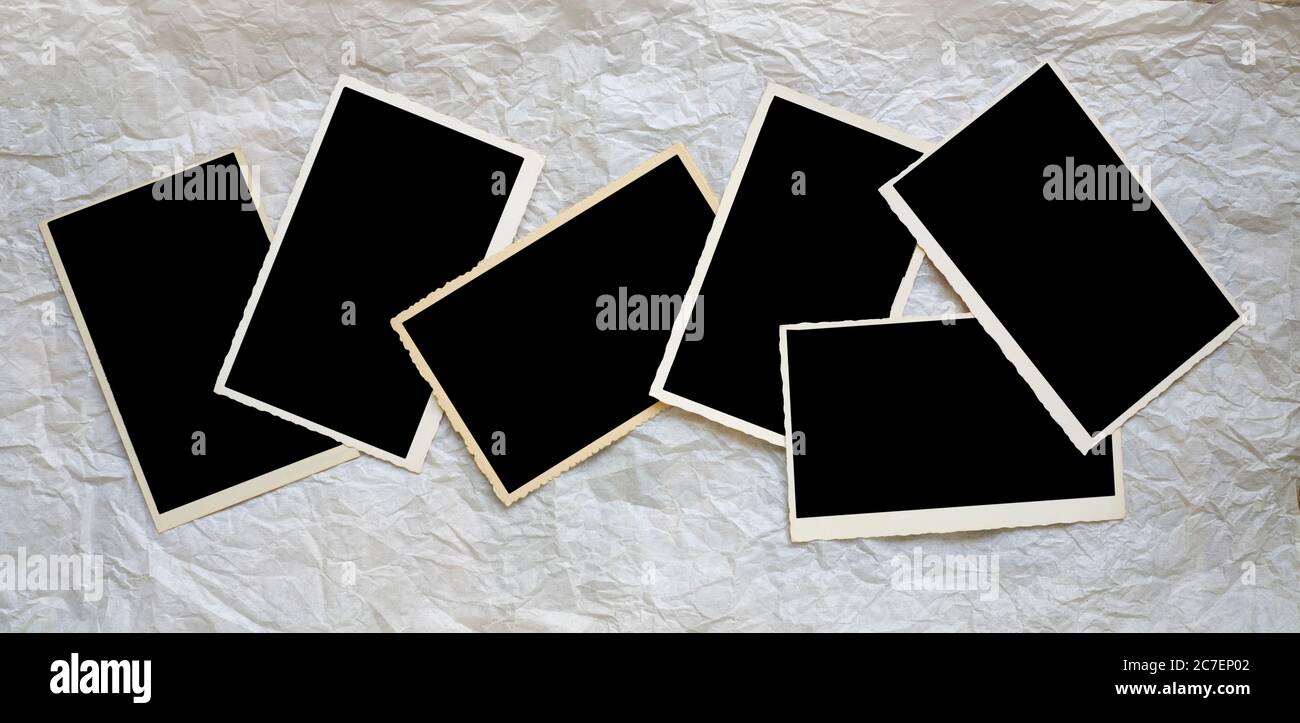old empty photo frames, vintage photo prints on crumpled paper with ...
