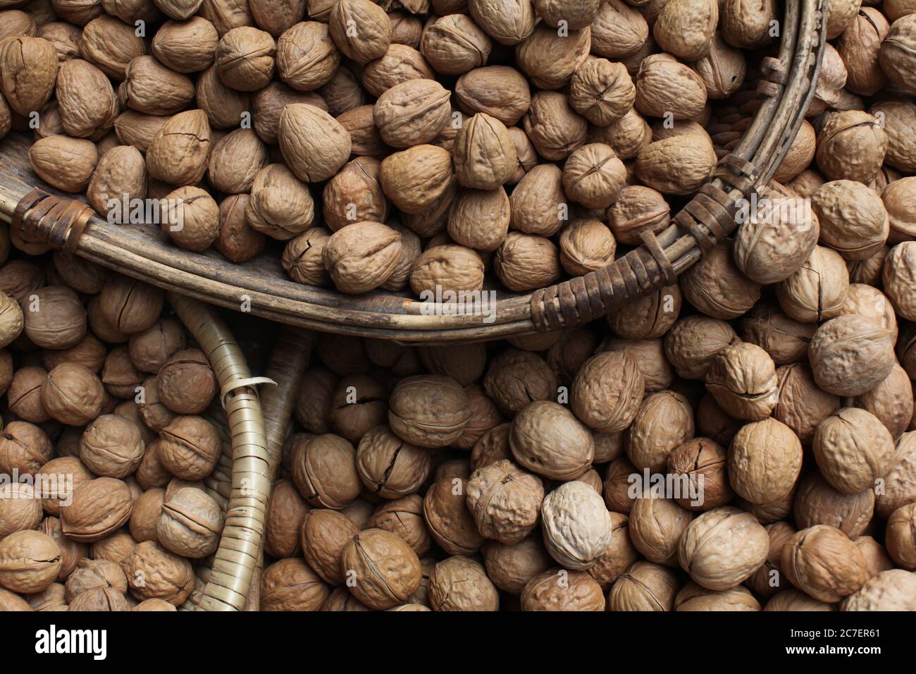 Closeup shot of a lot of walnuts in a basket during daytime Stock Photo ...