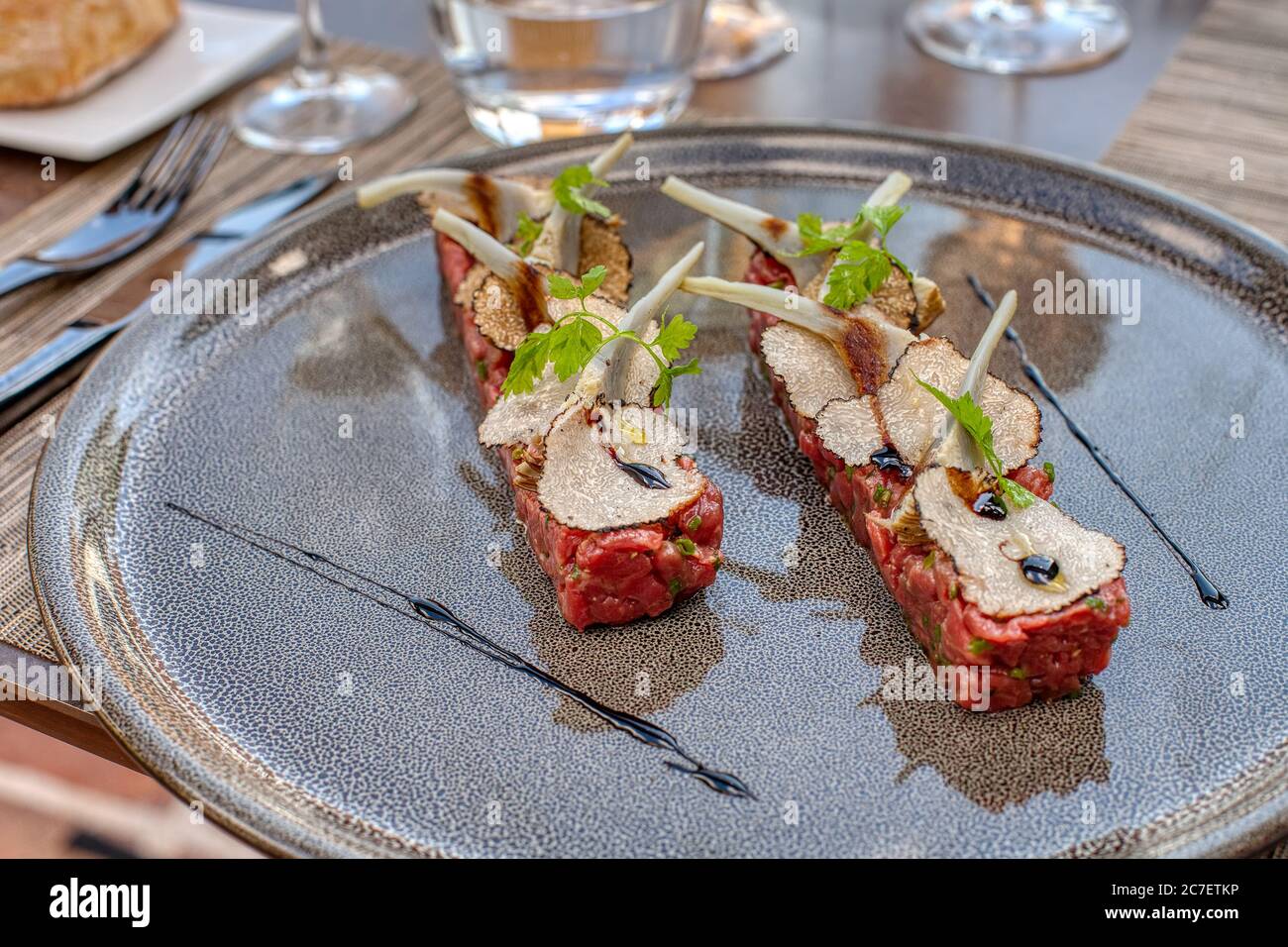 Beef tartare with black truffles and artichoke Stock Photo - Alamy