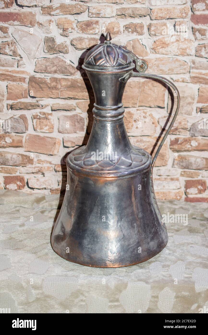 Very old style metal ewer water jar in view Stock Photo - Alamy
