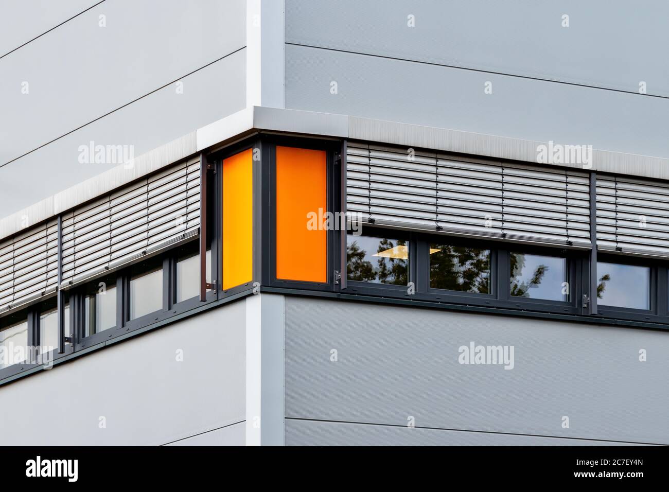 Horizontal shot of a grey building with open windows and grey window ...