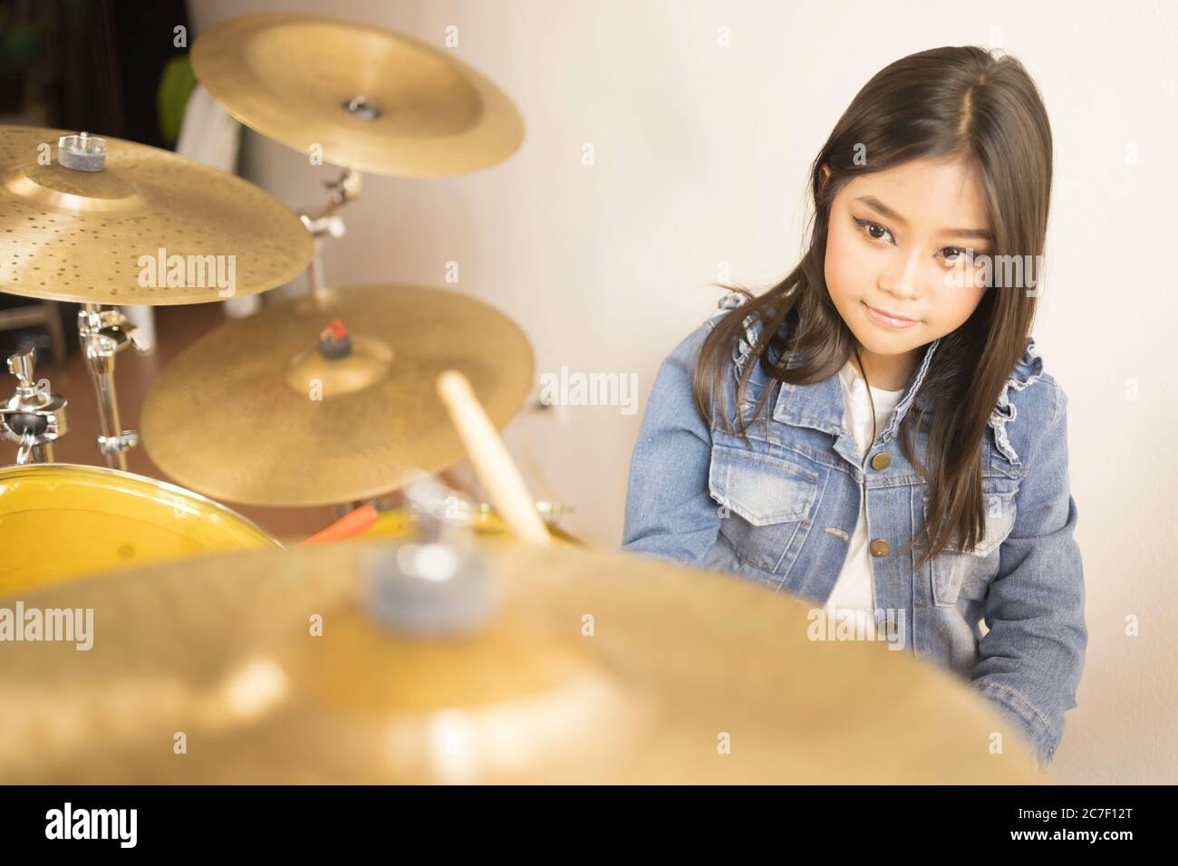 Asian girl playing drum hi-res stock photography and images - Alamy