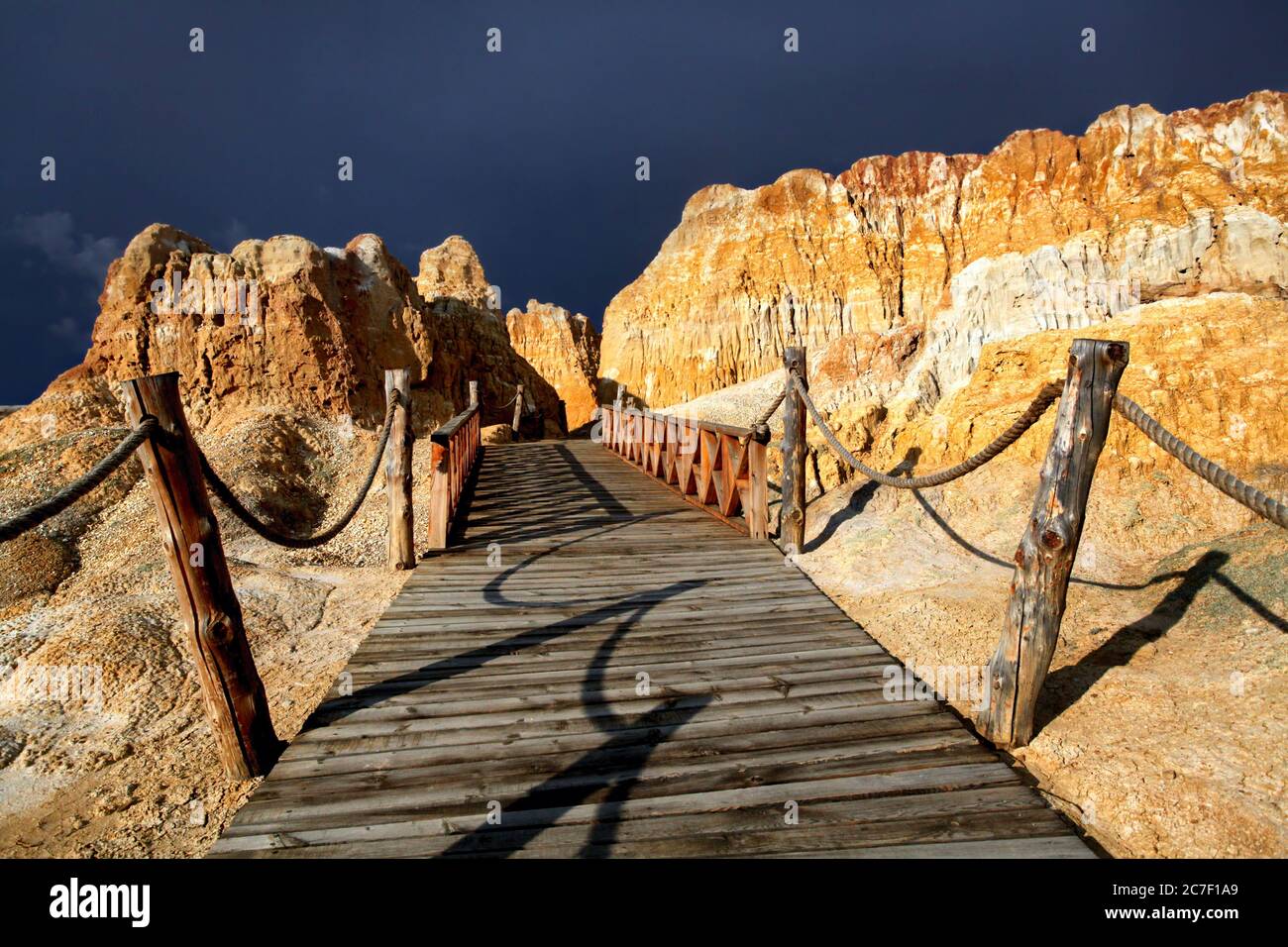 Horizontal shot of a trail with wooden railings between beautiful high ...