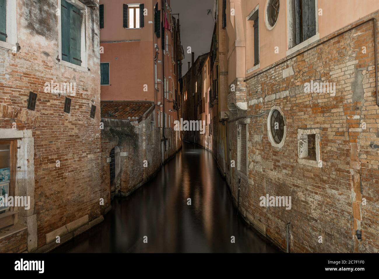 Horizontal shot of a canal between the old buildings in Venice, Italy ...