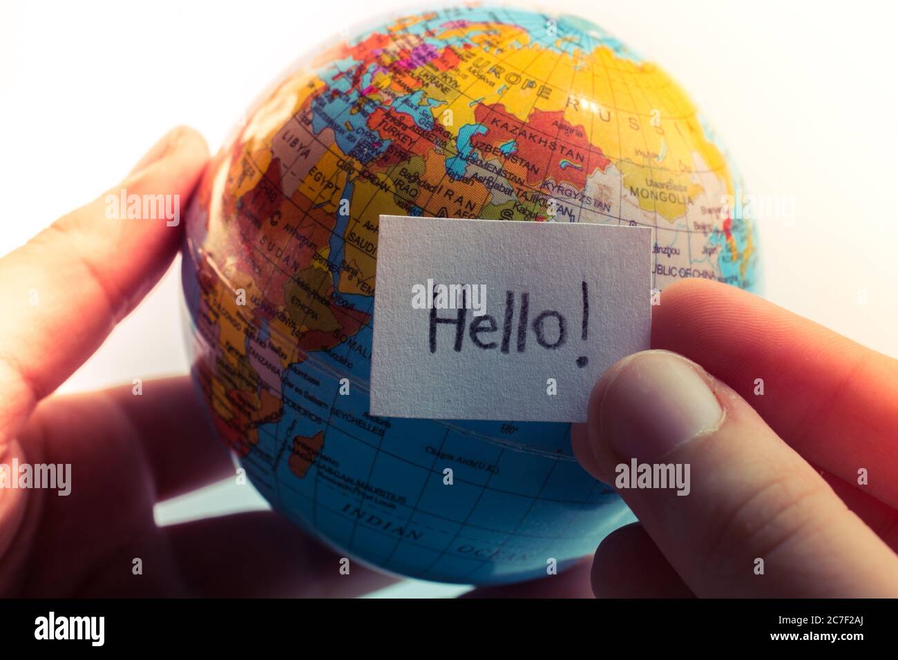 Hand holding notepaper with HELLO wording on model globe Stock Photo ...