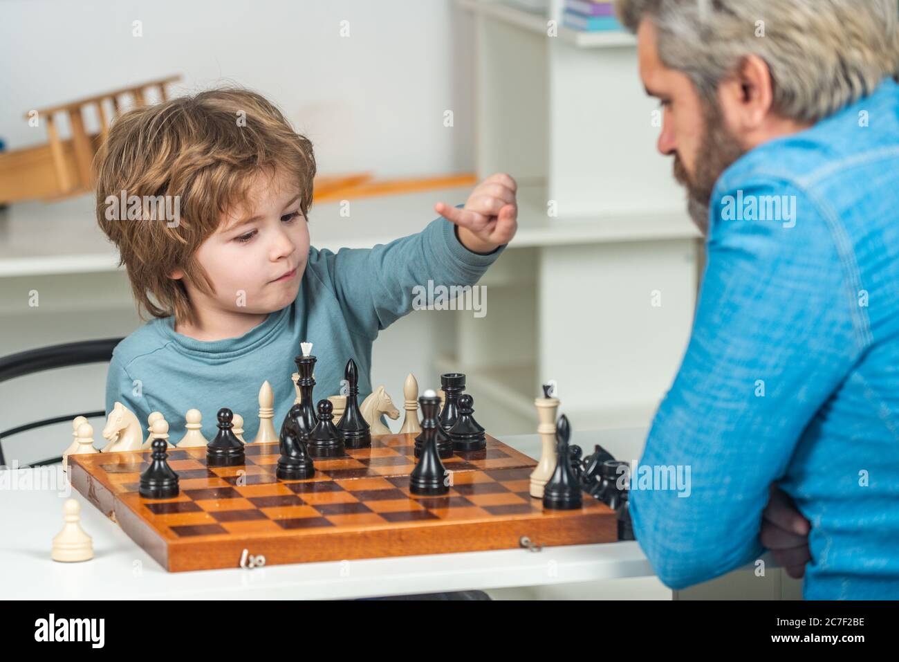 Father with son playing Chess at home. Back to school. Father teaching ...