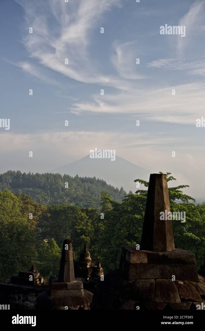 Vertical shot of ruins with forested mountains in the distance under a ...