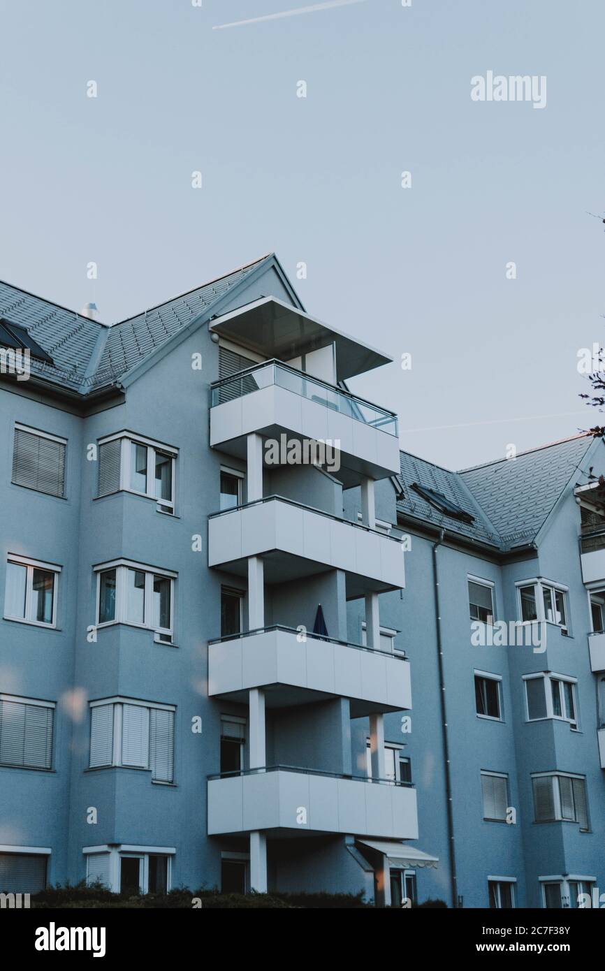 Pastel blue modern building with white windows Stock Photo - Alamy