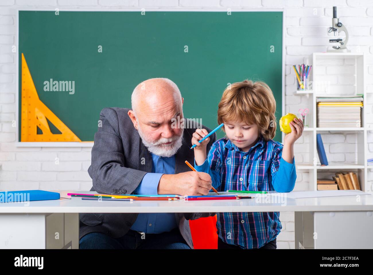 Elementary school. Senior teacher in classroom with elementary school ...
