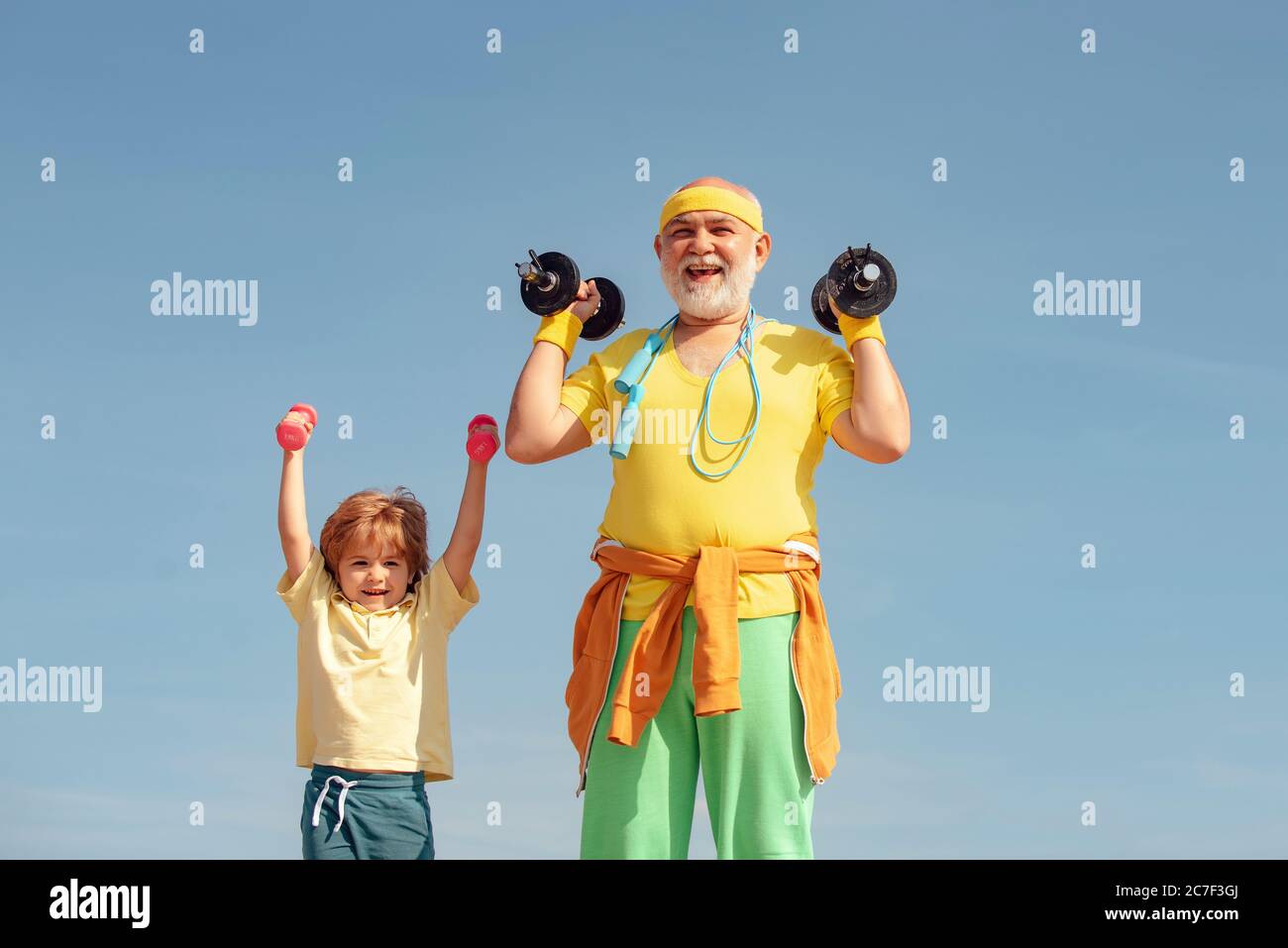 Grandfather and child do morning exercise. We exercise every day ...