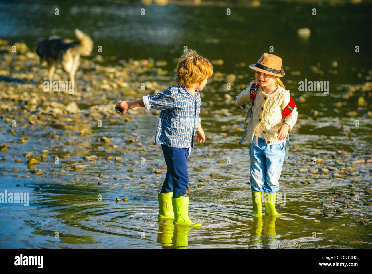 Kids playing by the Stony river. Summer activities for children. Little ...