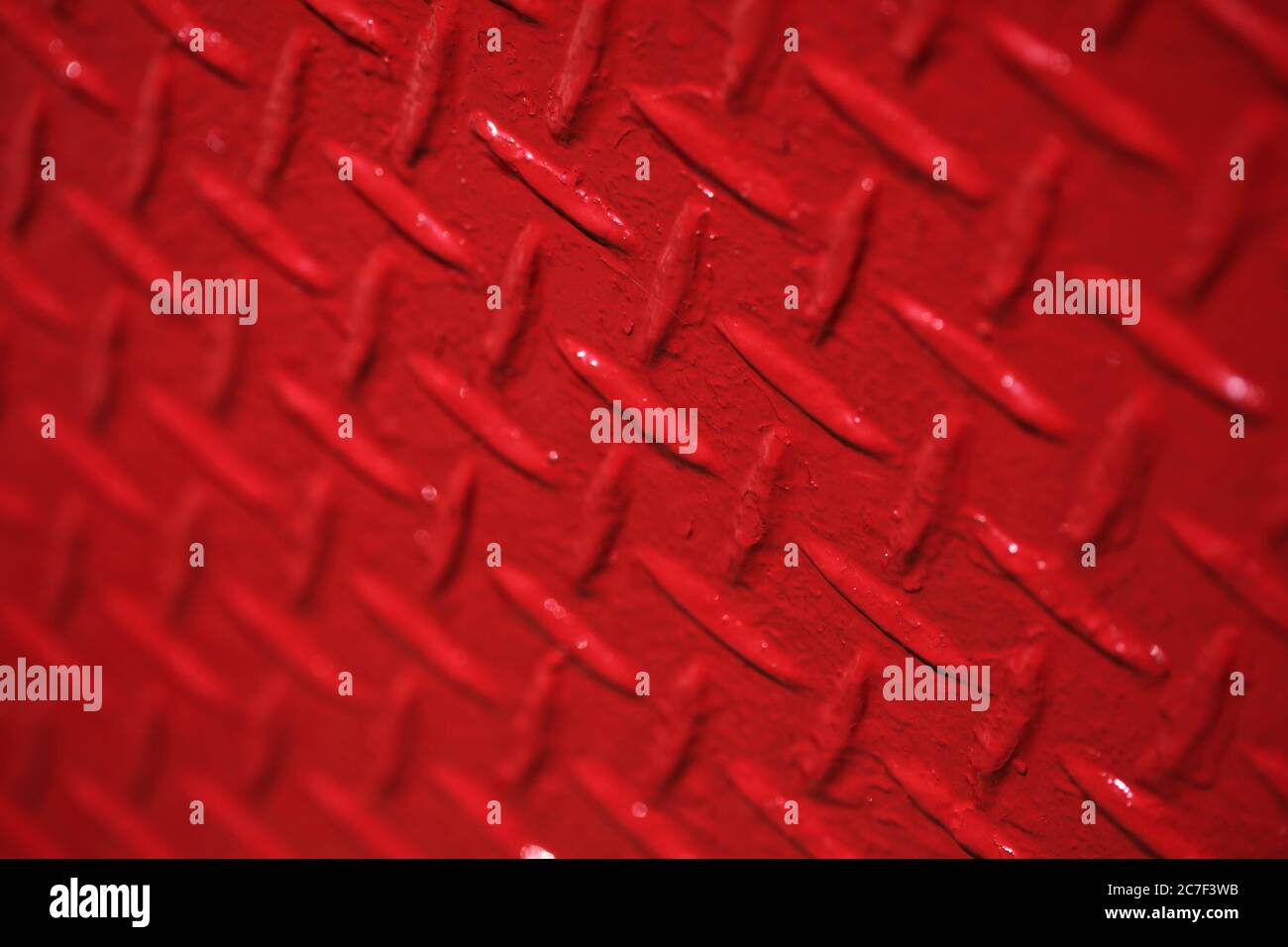 Closeup shot of a painted red metal texture with unique patterns as a ...