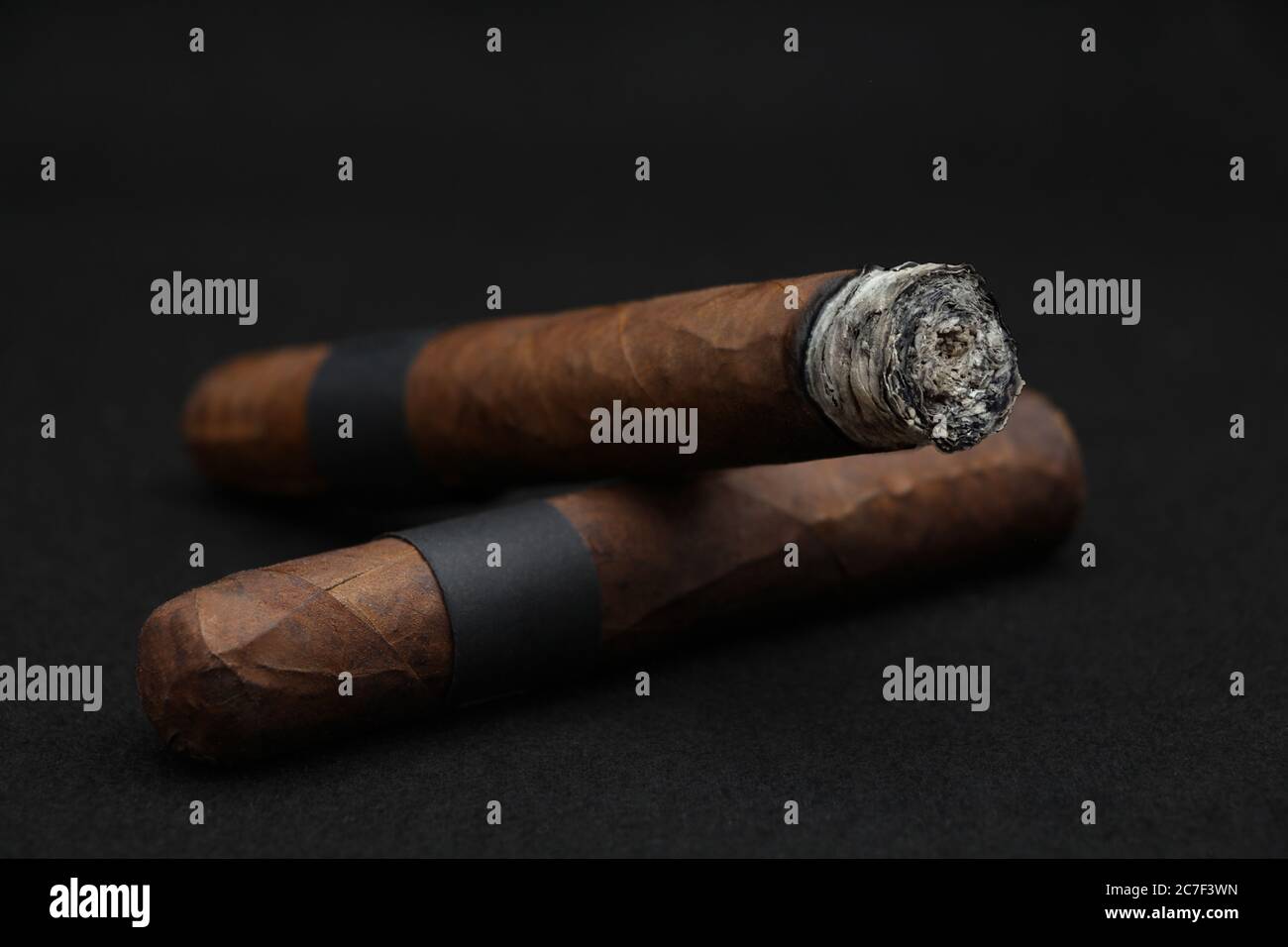 Double robusto cigars with dark wrapper on black background Stock Photo ...