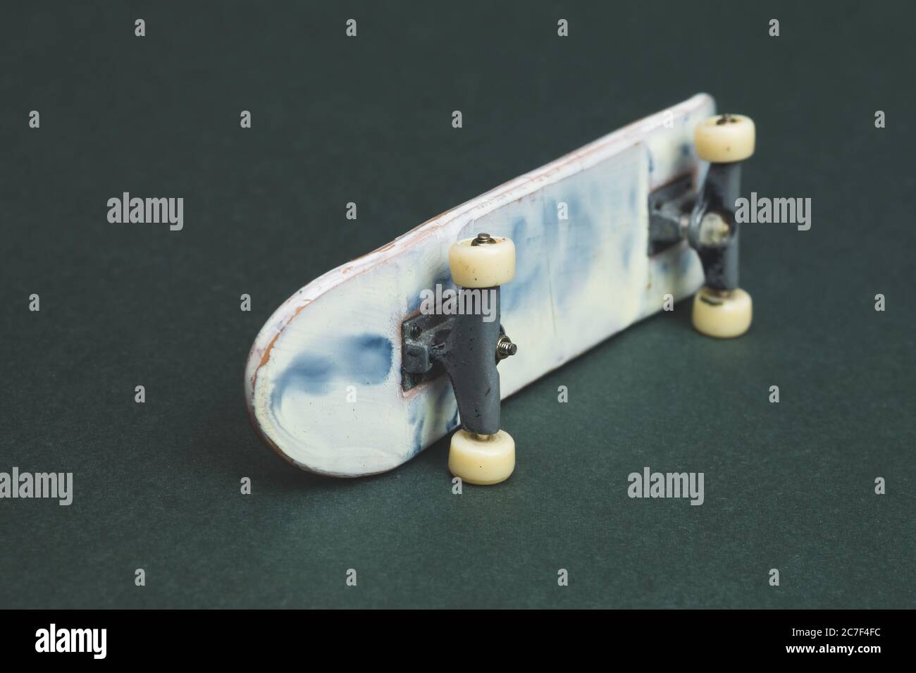 Small skateboard on color background. tiny skate for fingers ...