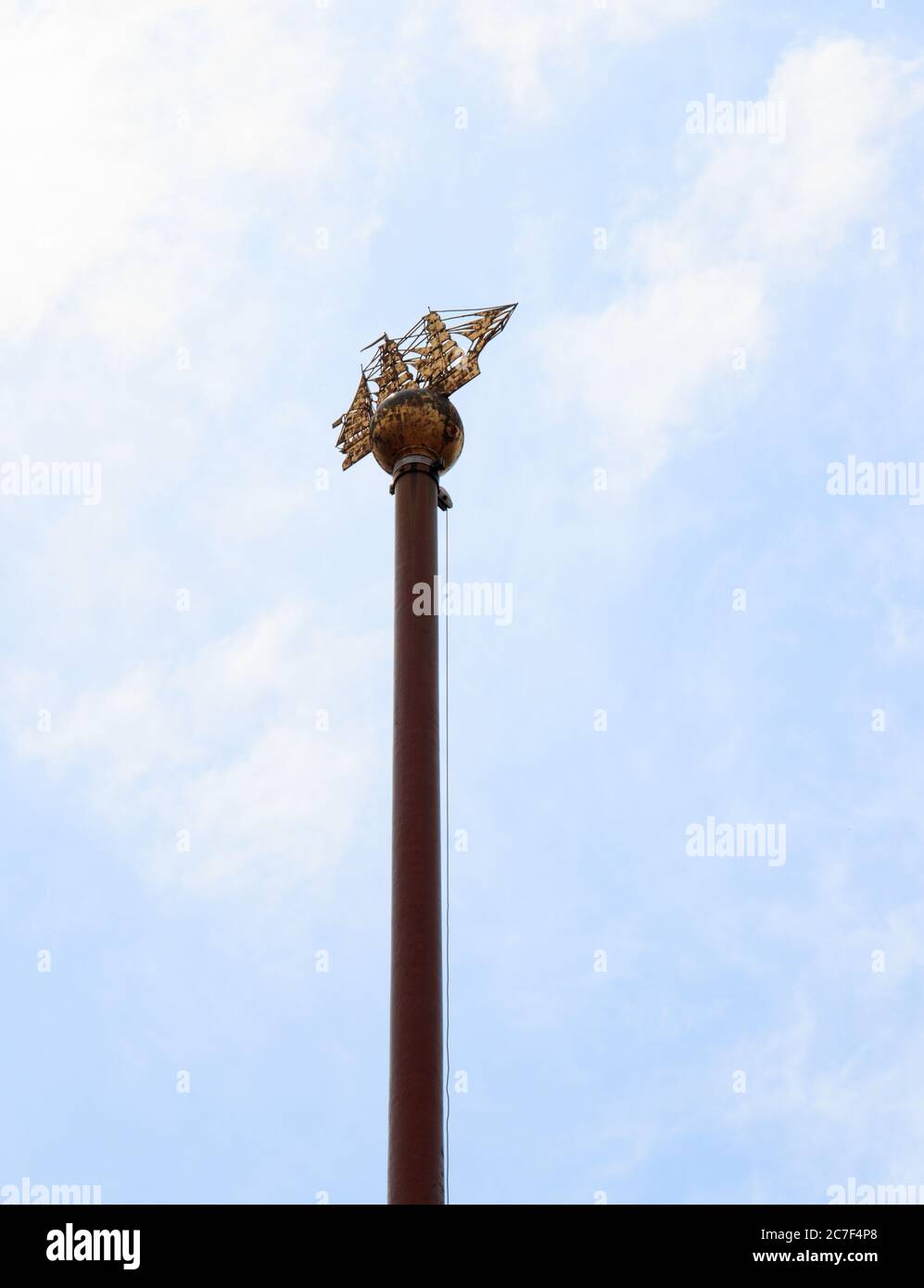 Low angle shot of a pillar with a ship symbol on top standing under the ...