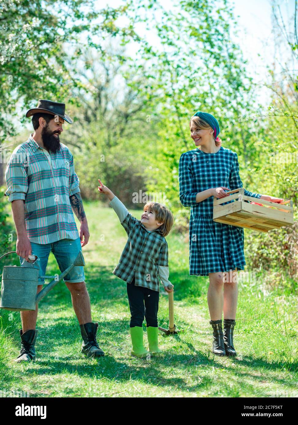 Beautiful young smiling family having fun at farm yard. Earth concept ...