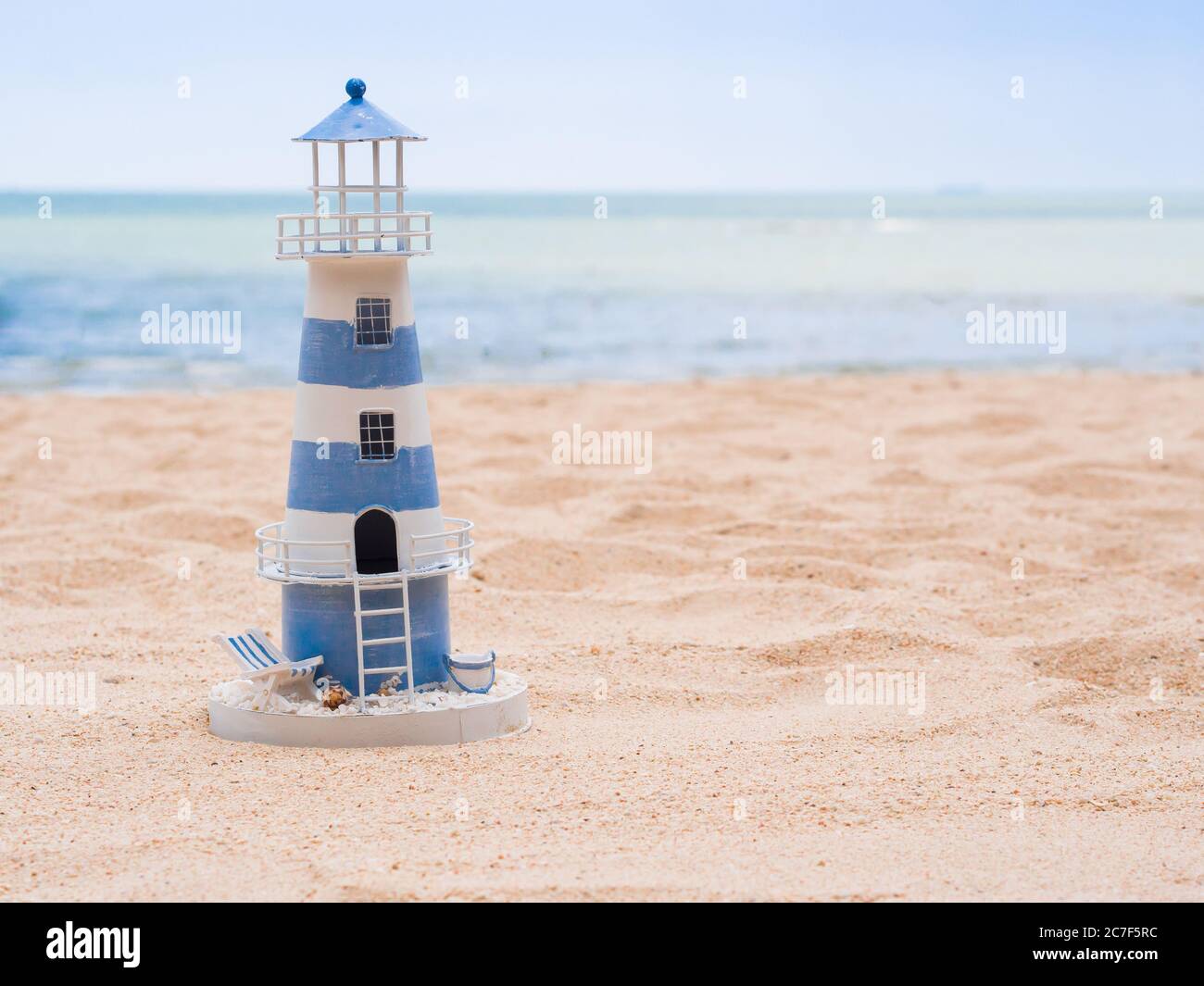 Lighthouse model on the sand beach Stock Photo - Alamy
