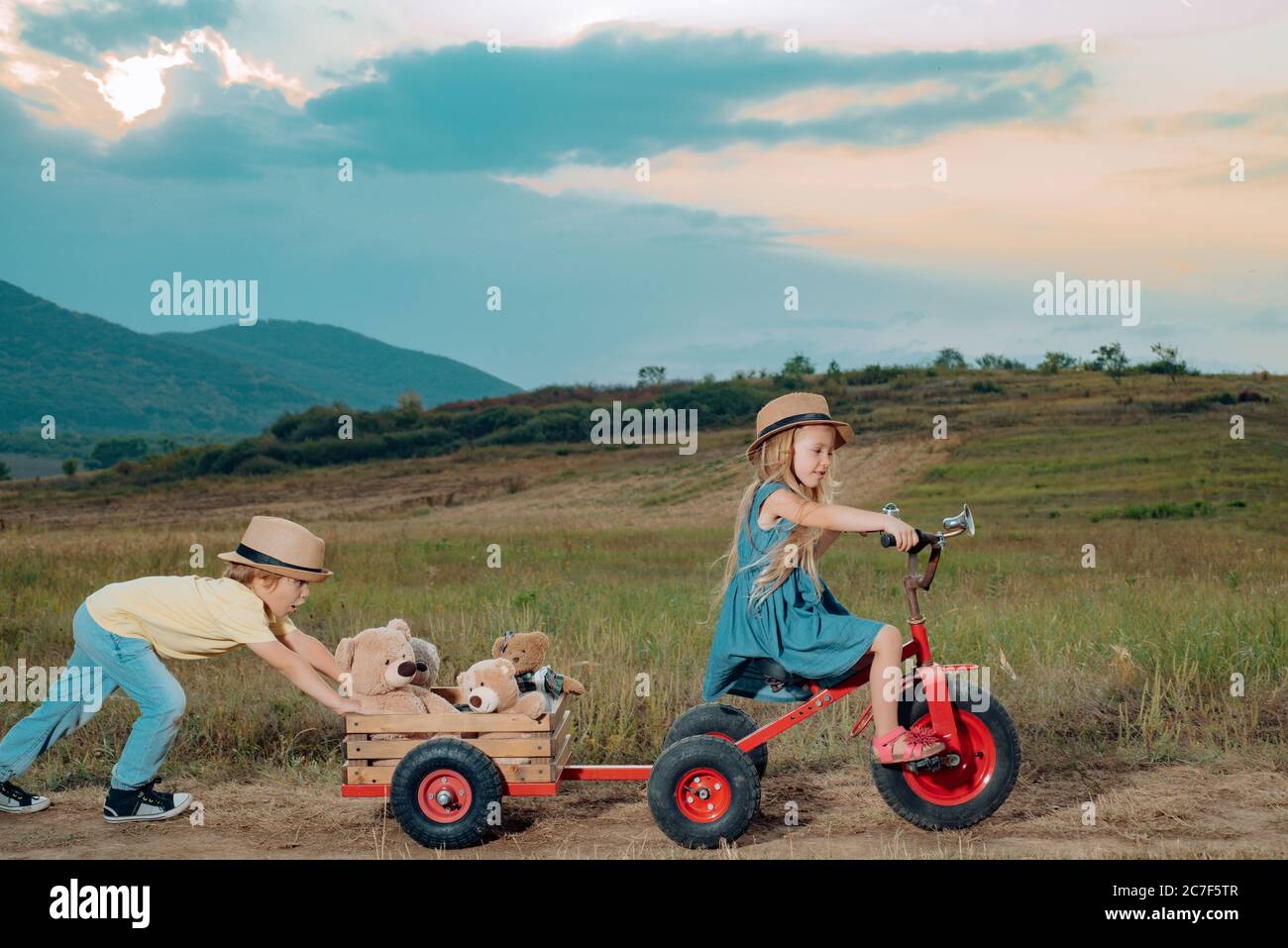 Positive little girl and boy. Little children have fun on fresh air ...