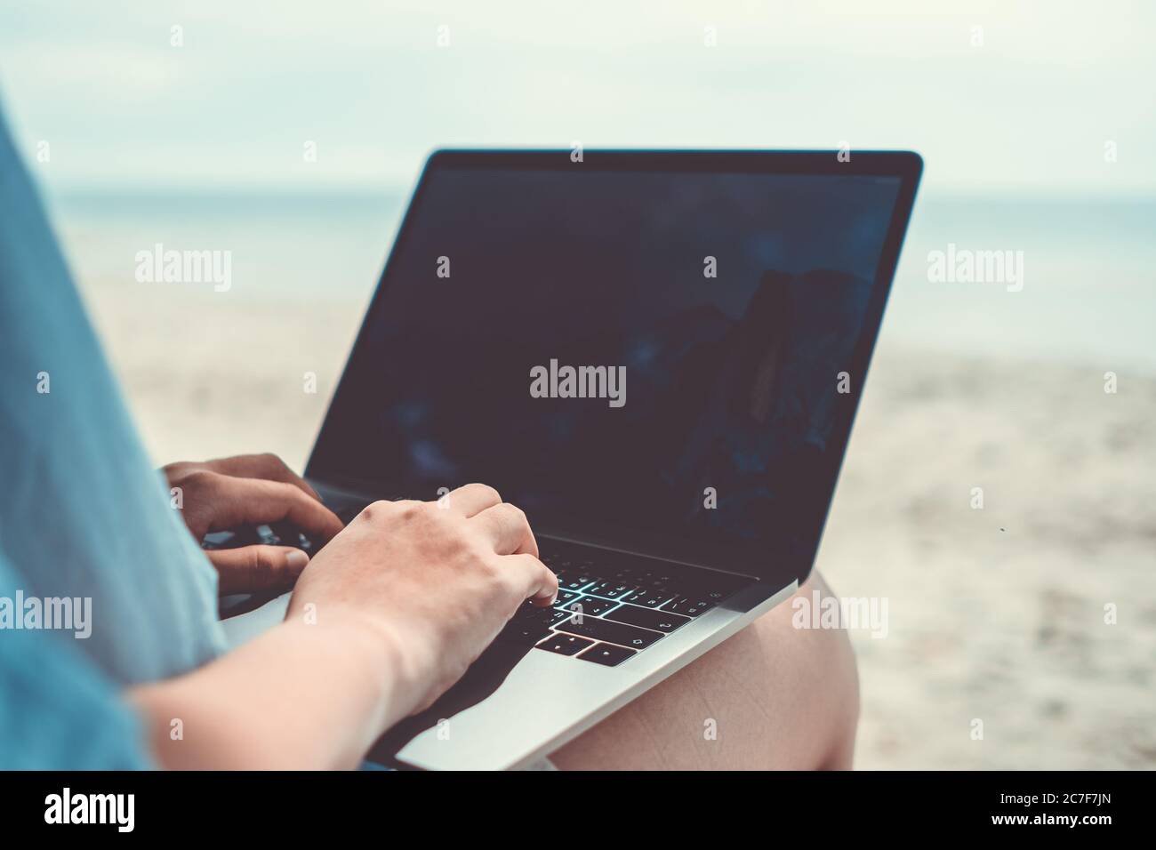 Woman using laptop and smartphone to work study in vacation cady at ...