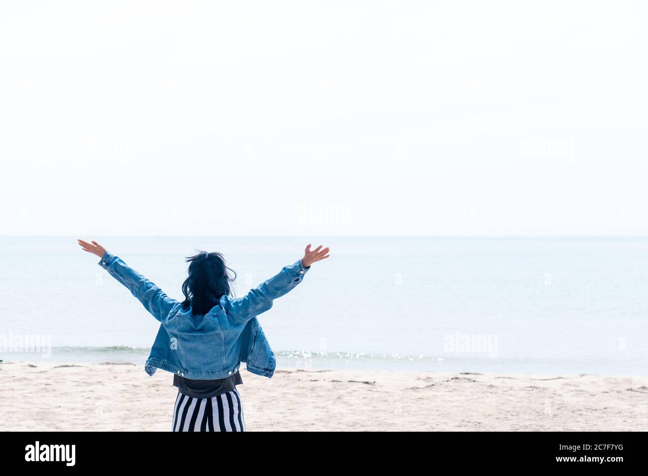 Woman rise hands up to sky freedom concept with sunset sky and summer ...