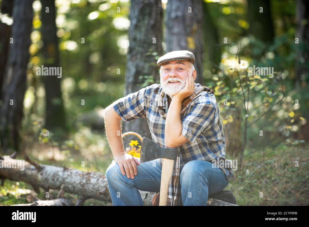 Thoughtful man. Farmer sit on wood. Happy forester. Human and nature ...