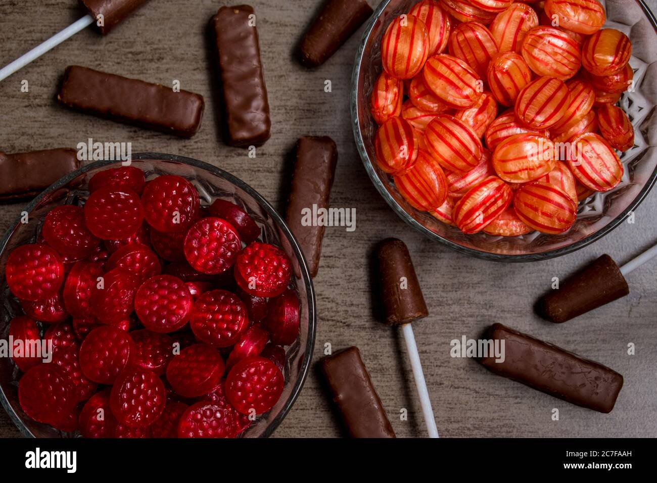 Different candies like chocolate, blackberry candies and orange lined ...