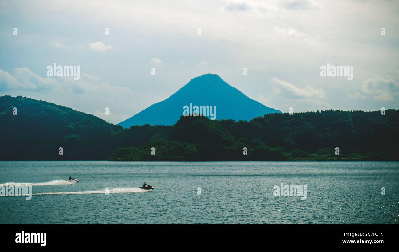 Beautiful scenery of jet skis on Lake Ikeda at the Kaimon-Dake volcano ...