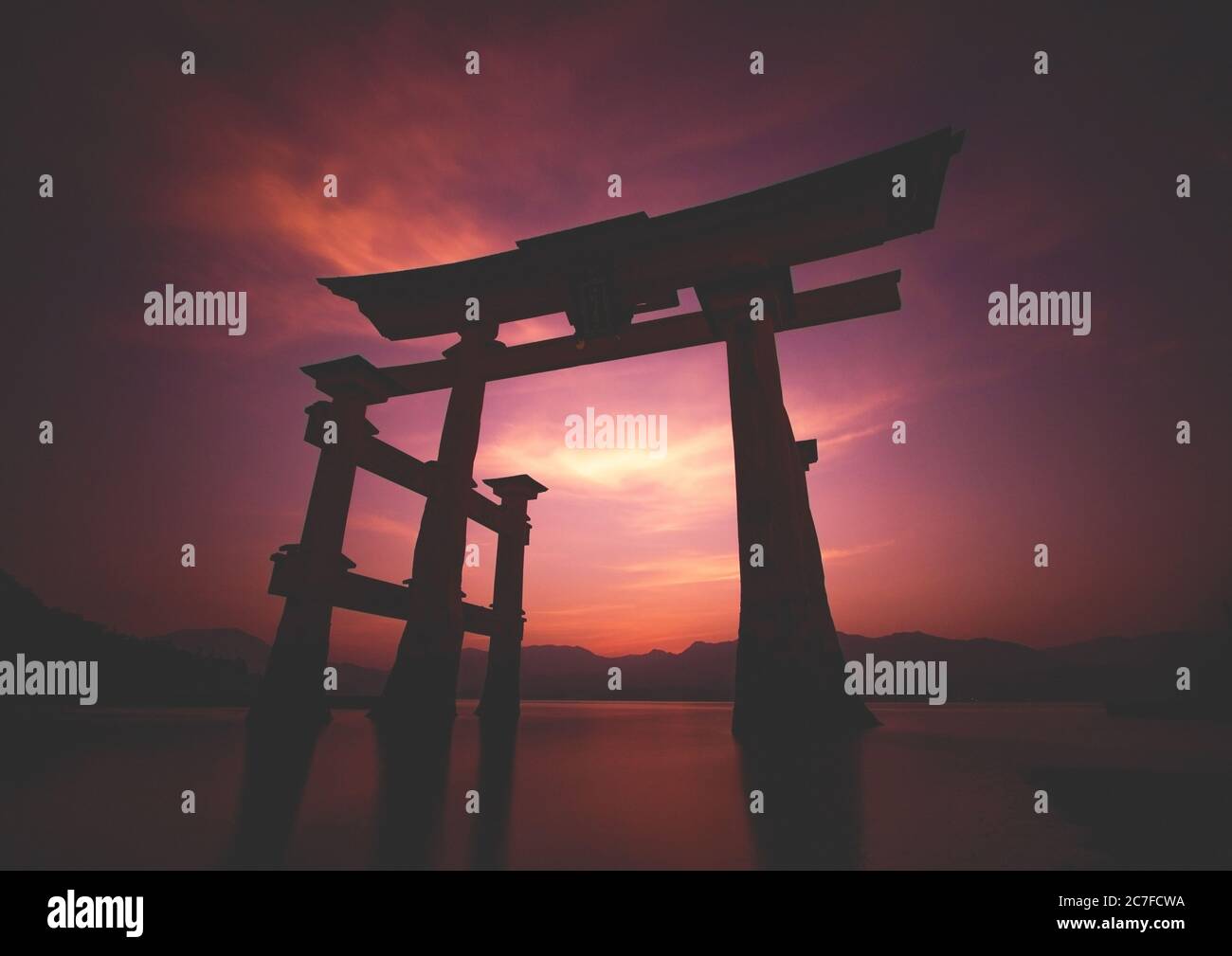 Breathtaking sunset over the famous historic floating torii of Miyajima ...