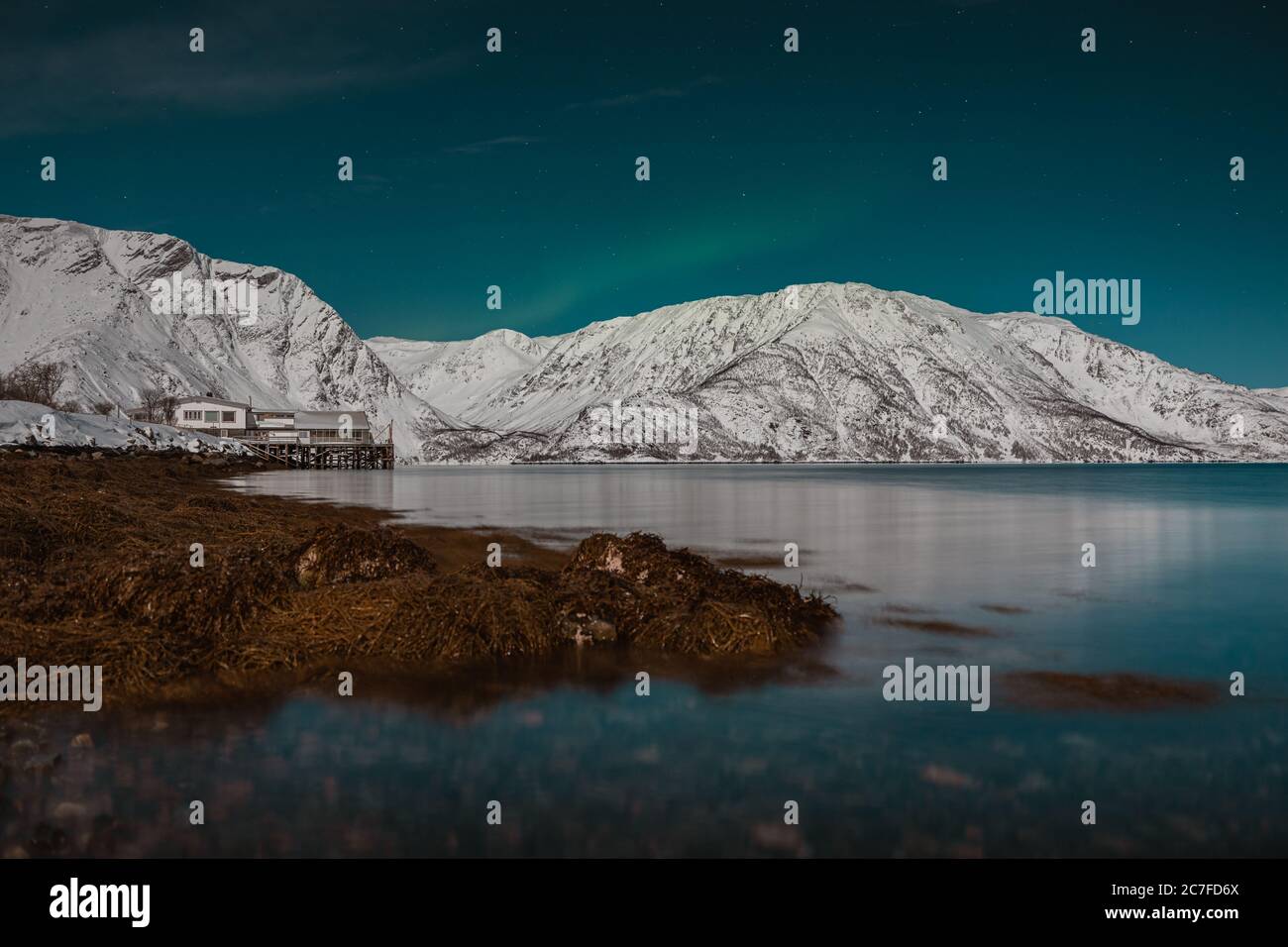 Marvelous scenery of a frozen lake surrounded by snowy mountains in ...