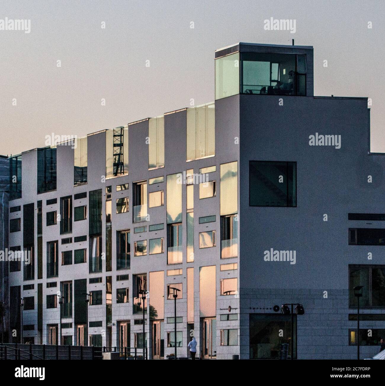 Low angle shot of a concrete building with glass windows under the ...