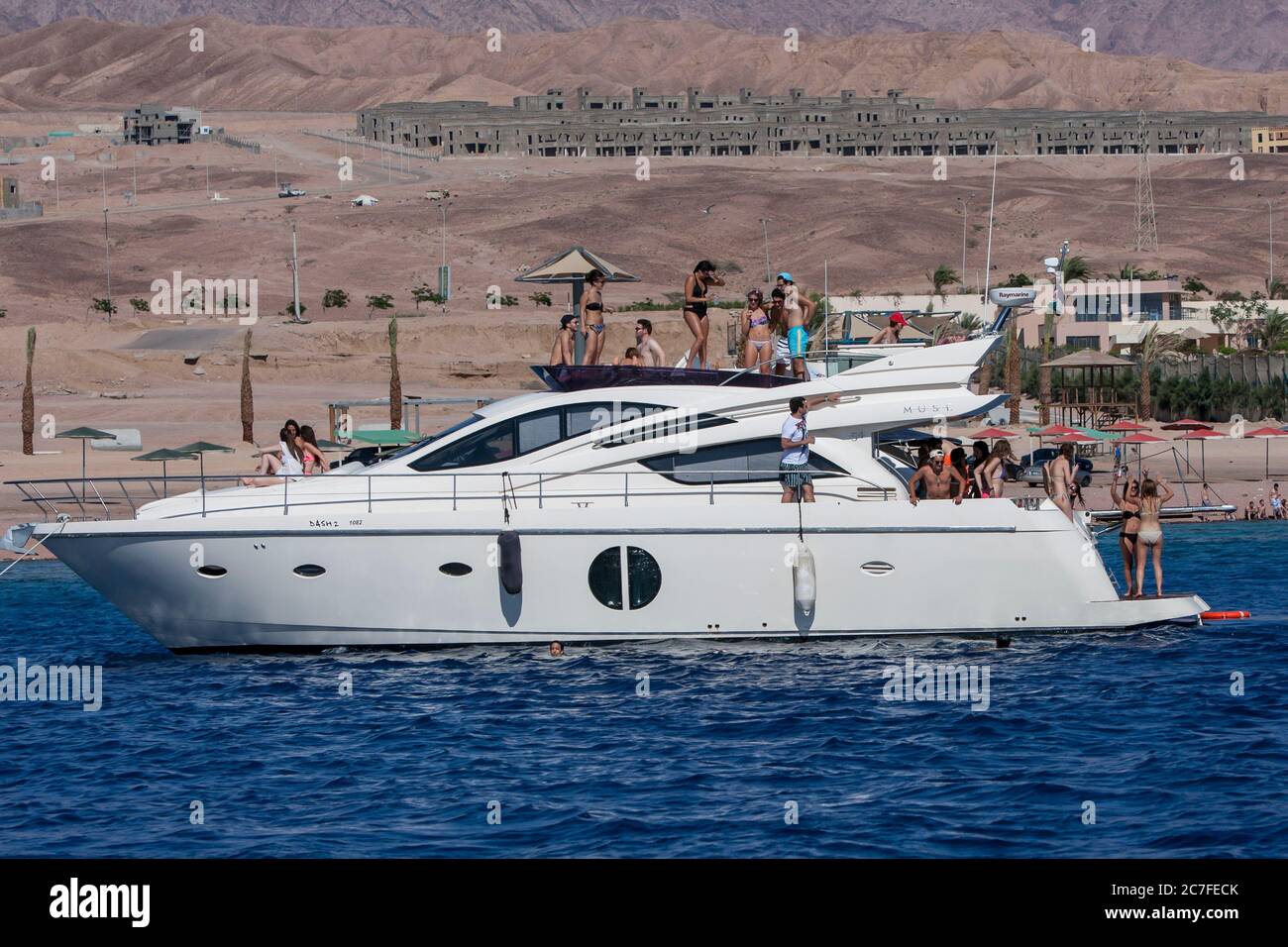 Visitors aboard a luxury boat, cool off in the waters of the Gulf of ...