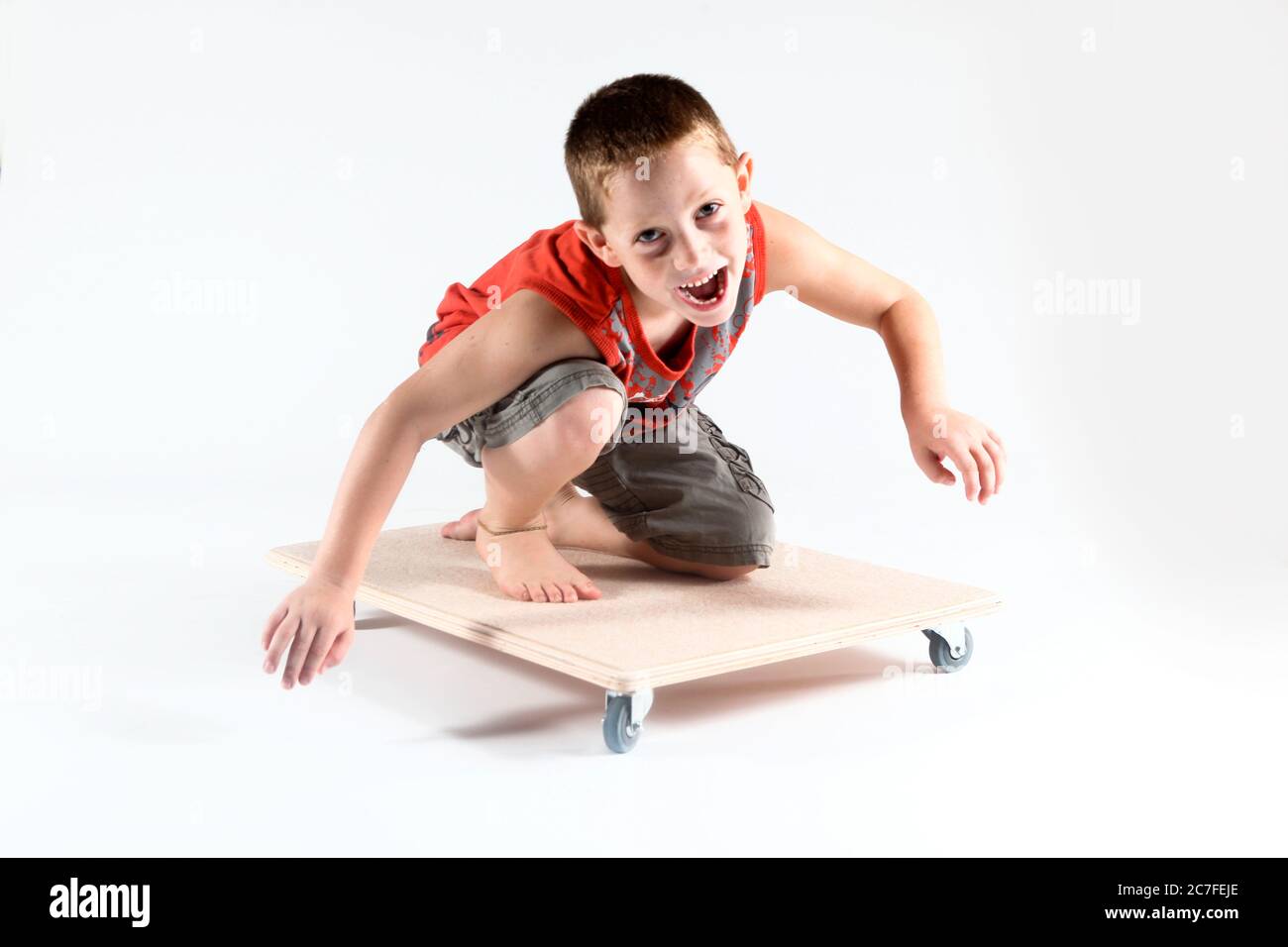 Indoor playground boy plays on wheeled board On white Background Stock ...