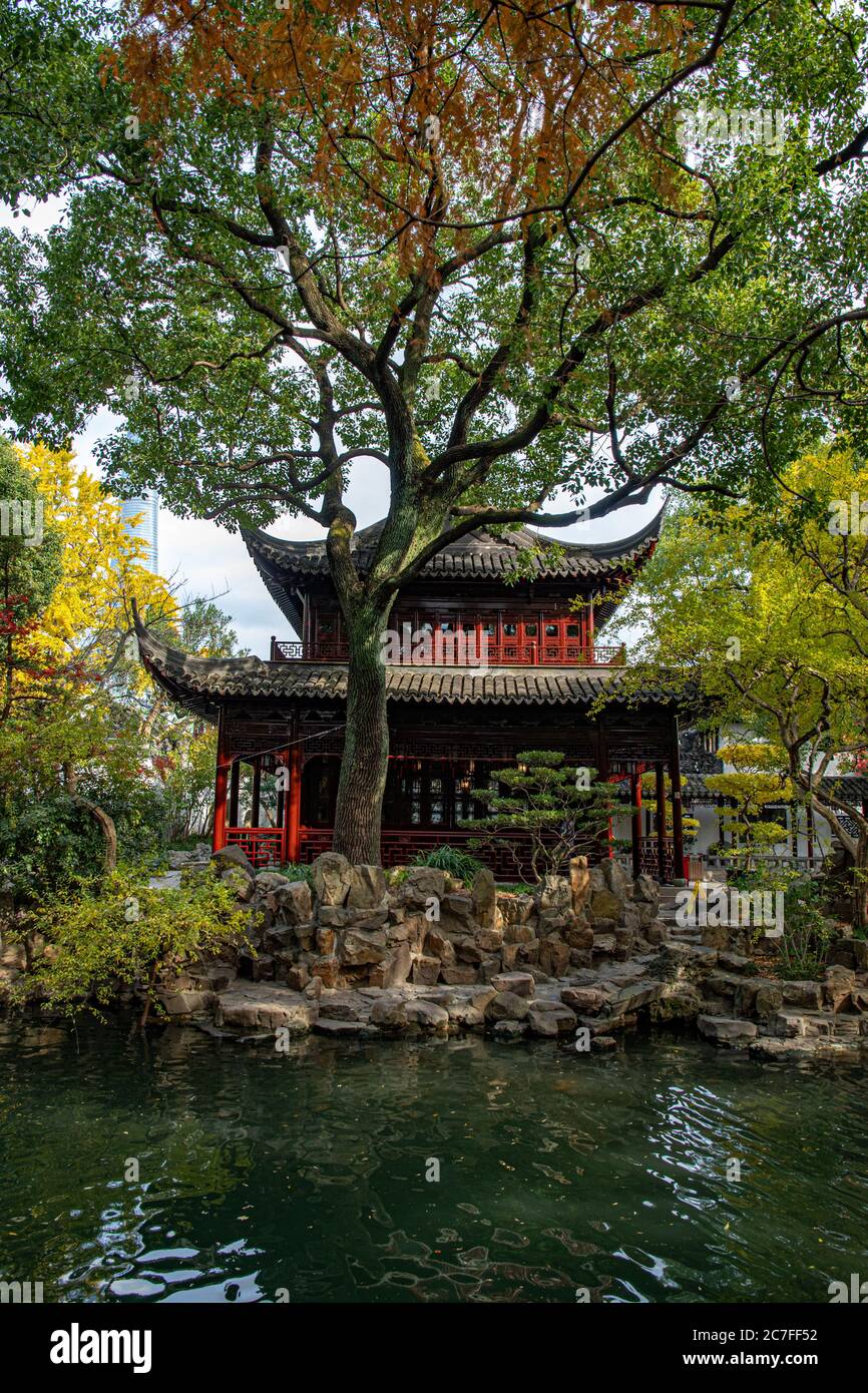 Ancient pagoda building in garden of autumn trees on pond shore Stock ...