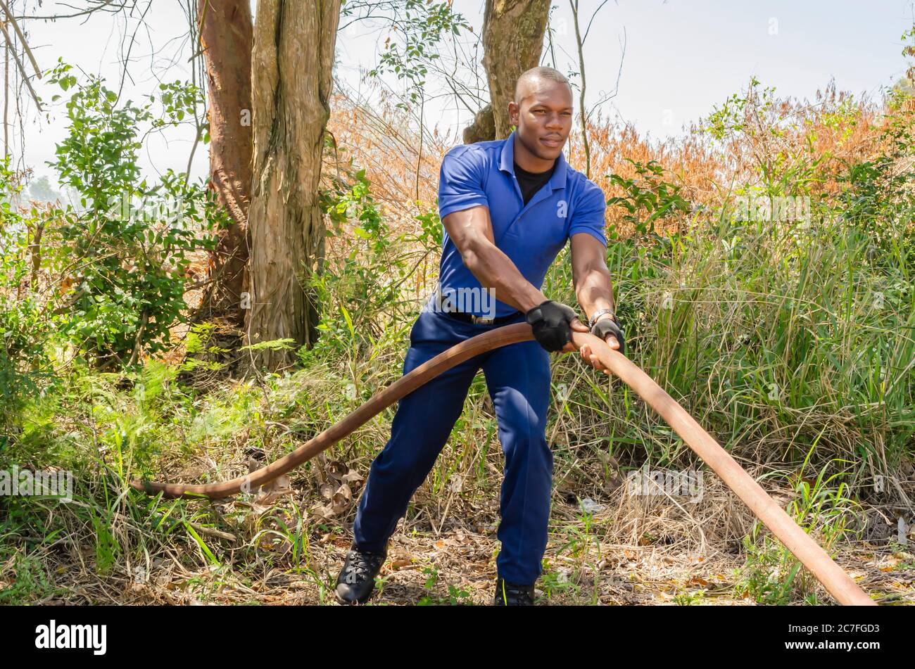 Fireman Pulling Water Hose Stock Photo - Alamy