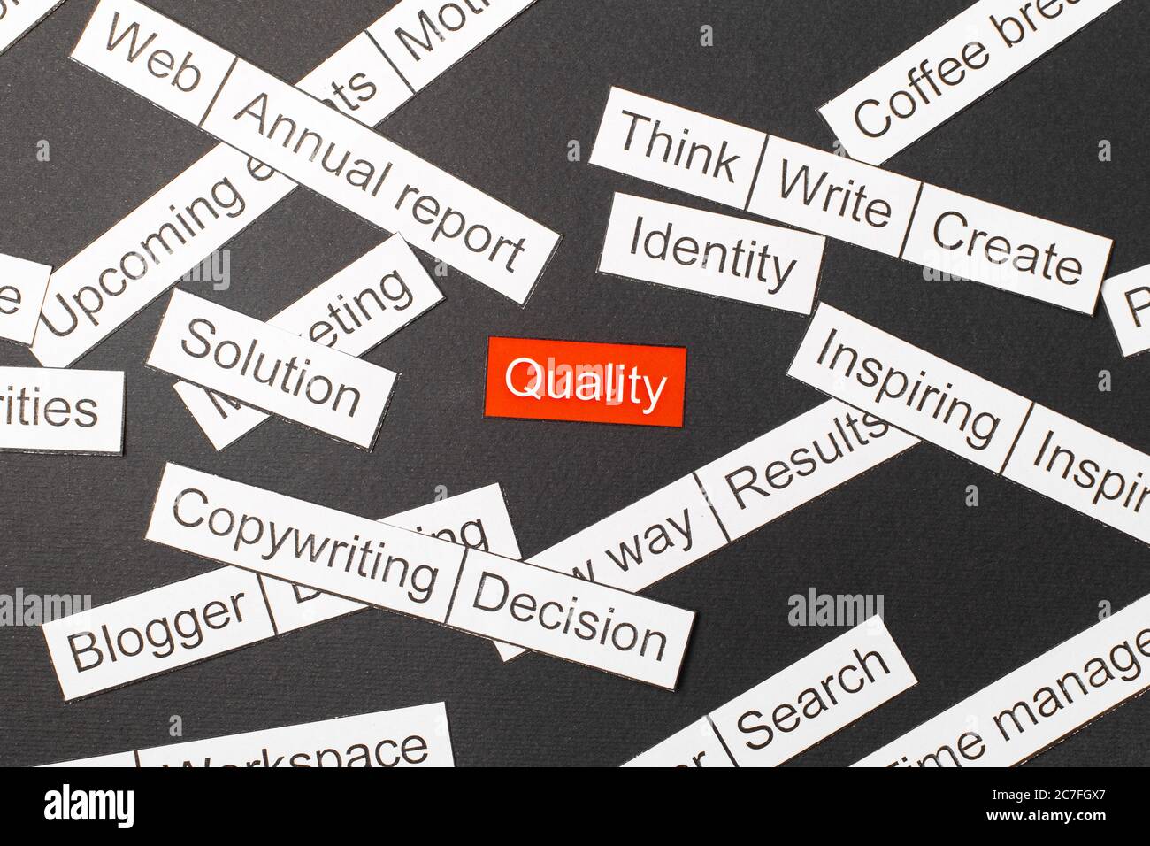 Cut paper inscription quality on a red background, surrounded by other ...