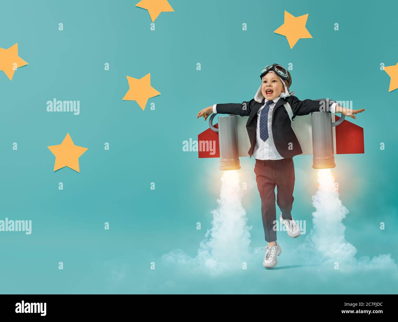 Little child in an astronaut costume is playing and dreaming of ...