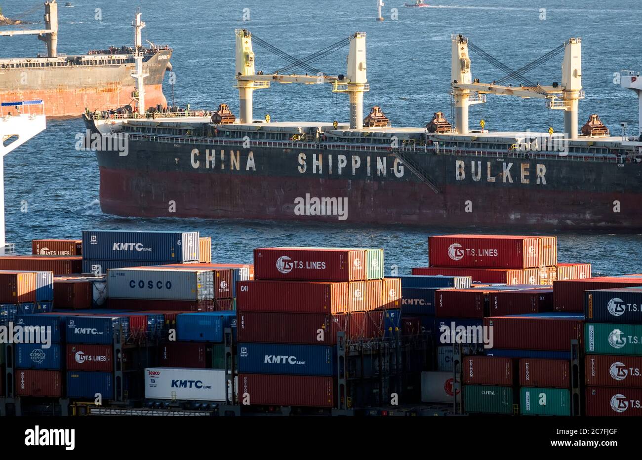 Container ships transporting cargo into Hong Kong from mainland China ...