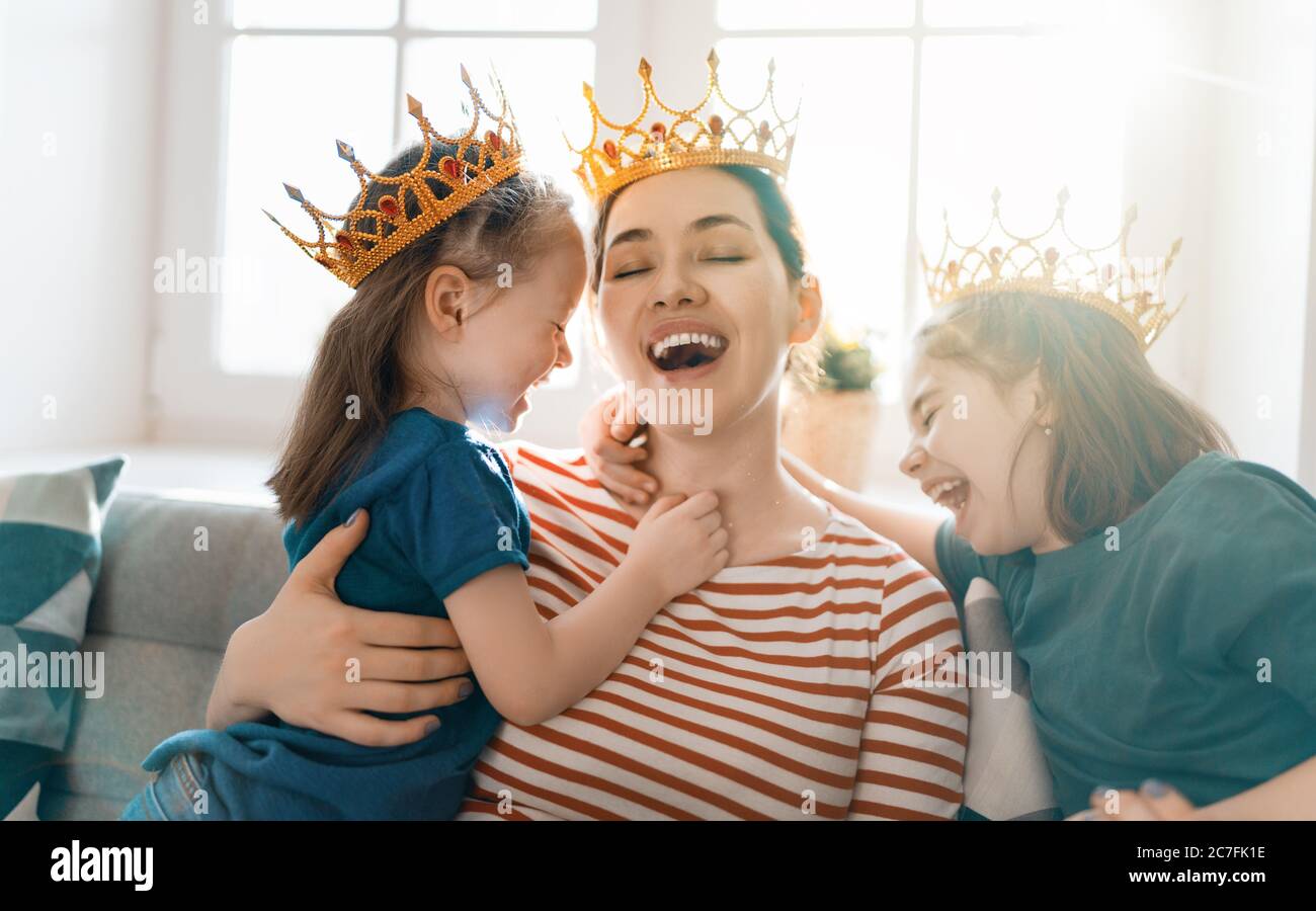 Happy loving family. Mother and her daughters children girls playing ...