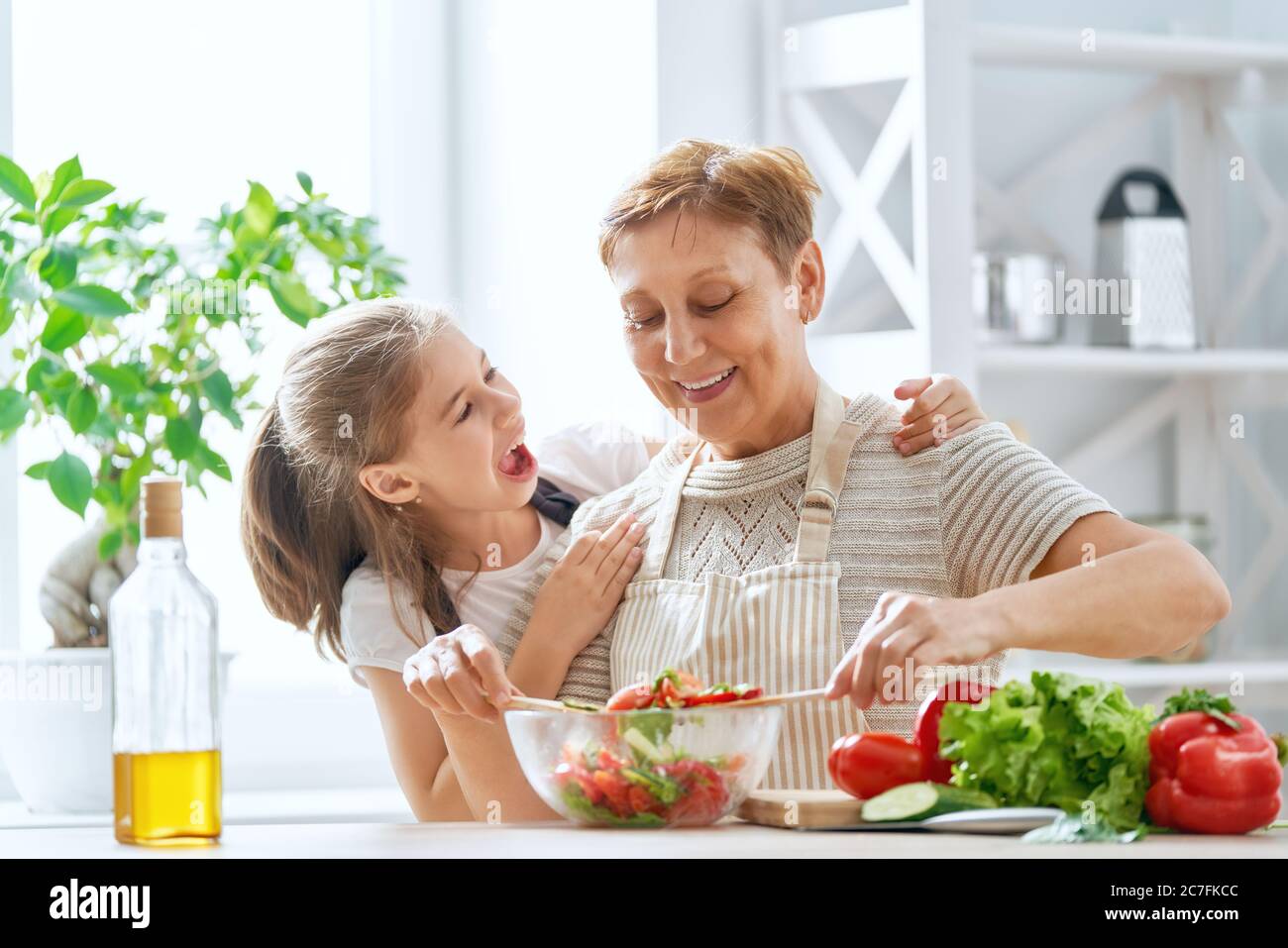 Healthy food at home. Happy family in the kitchen. Grandma and child ...