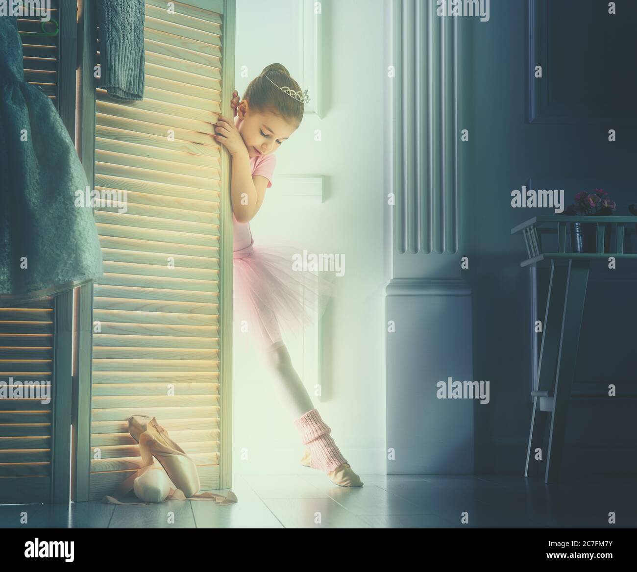 Cute little girl dreams of becoming a ballerina. Child girl in a pink ...