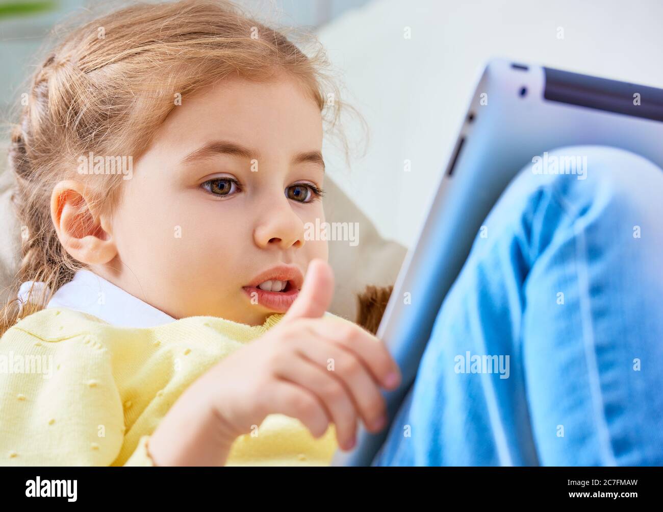 little girl using digital tablet Stock Photo - Alamy