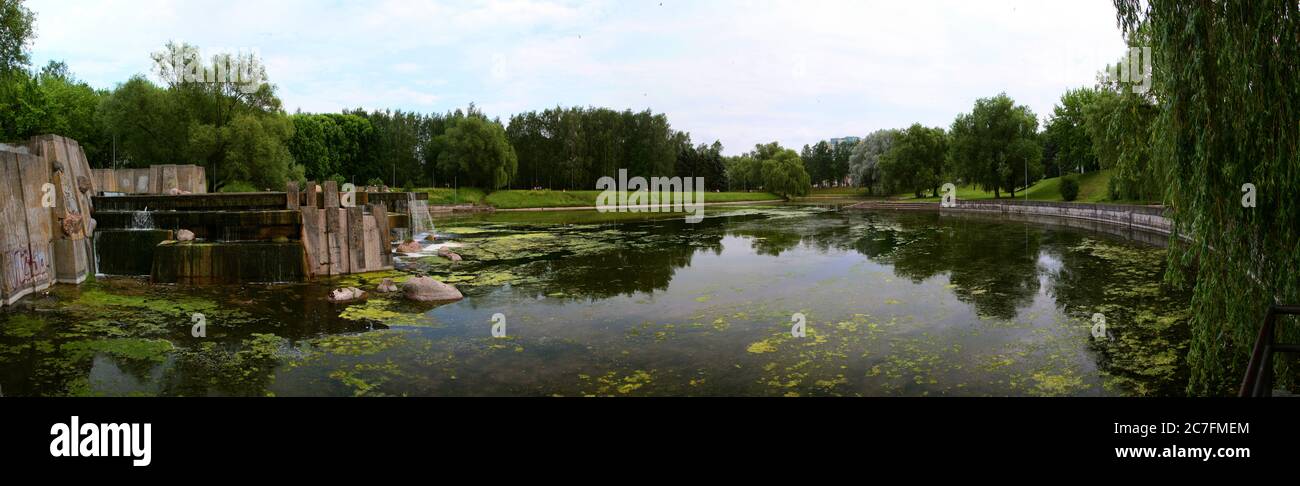 Panoramic summer view of a river with concrete cascades. Slepian Water ...