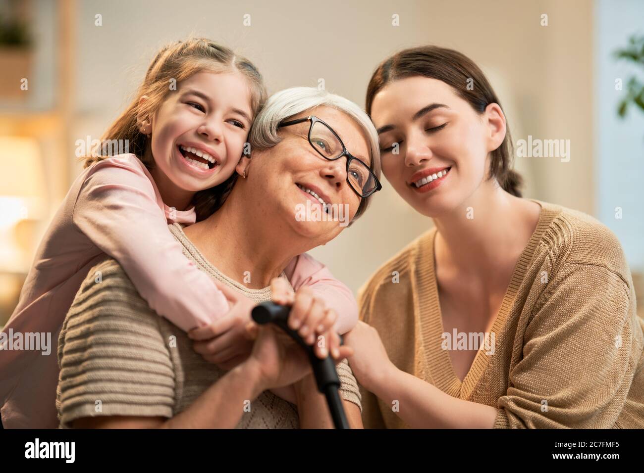 A nice girl, her mother and grandmother enjoying spending time together ...