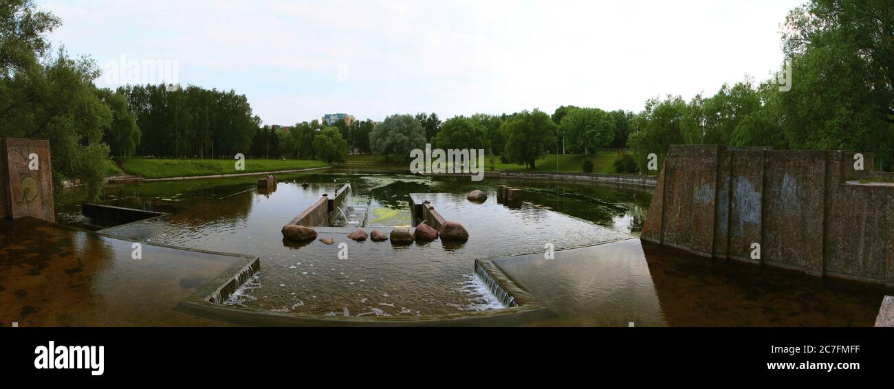 Panoramic summer view of a river with concrete cascades. Slepian Water ...