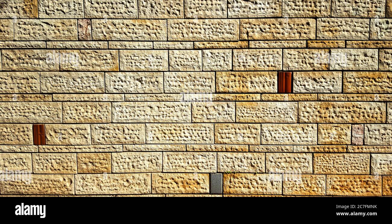 Stone Wall background from modern block building contruction facade ...