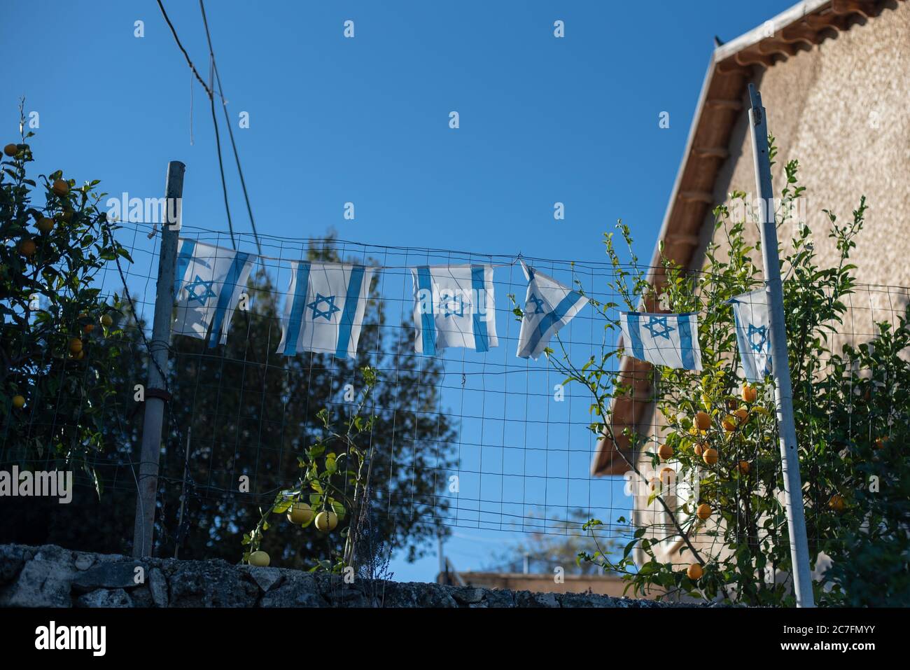 Low angle shot of Israel flags hung from the fences of a house Stock ...