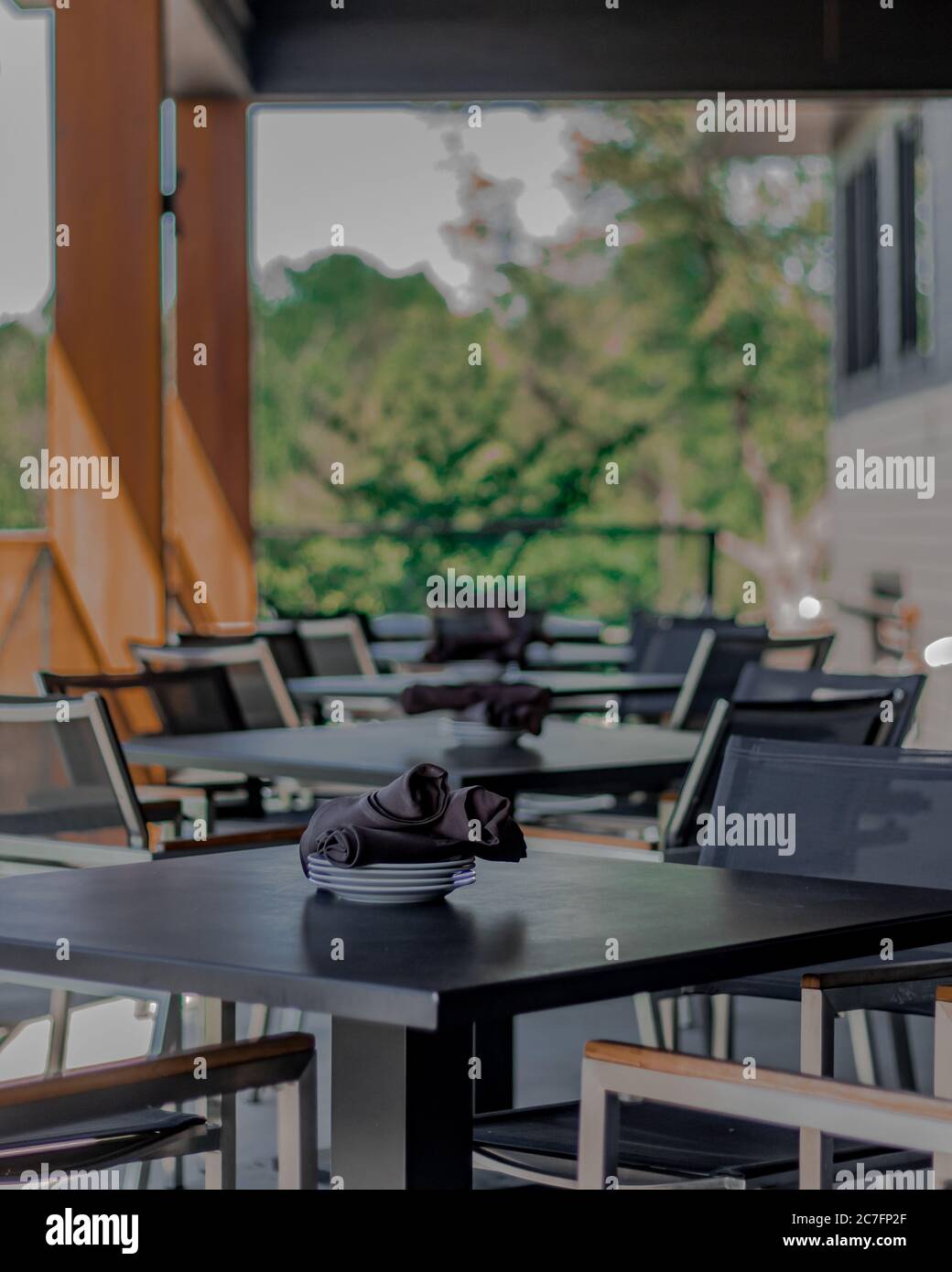 Vertical shot of neat tables in a nice, empty and clean restaurant ...