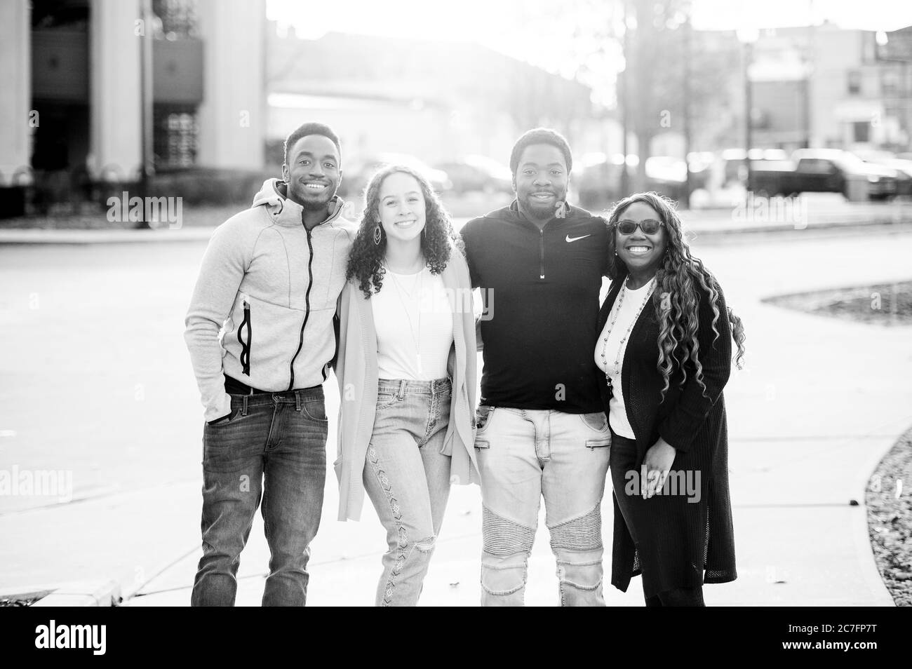 Cute greyscale shot of friends joking and laughing together Stock Photo ...